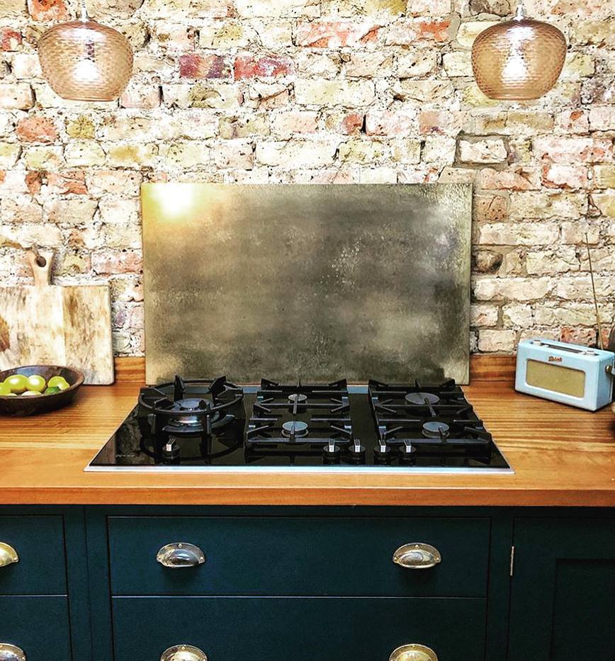 Small brass splashback, mottled finish | Kitchens